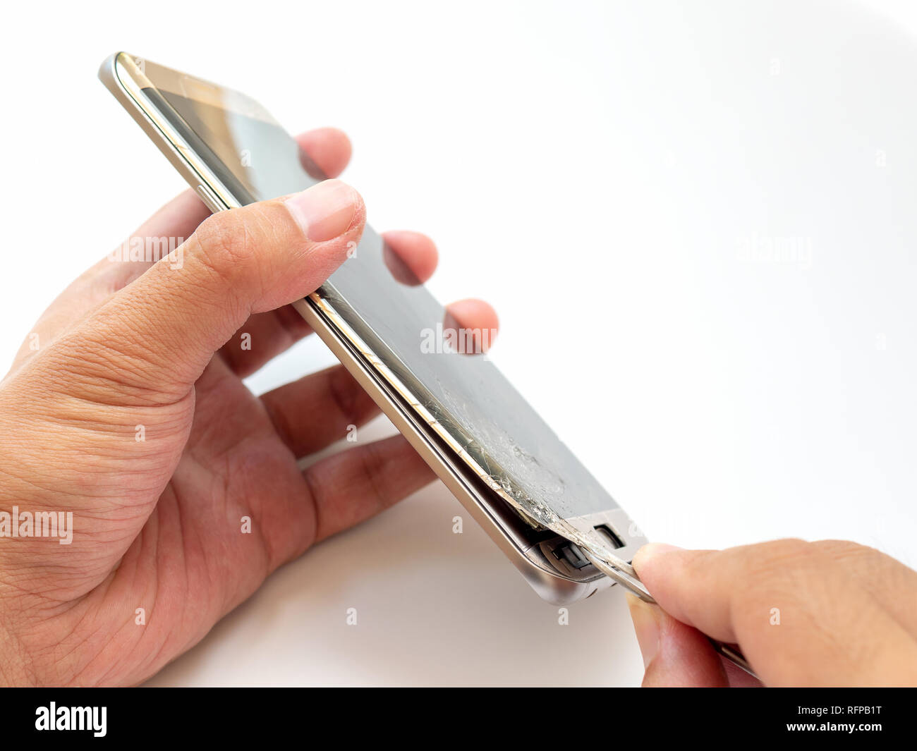 Close-up of technician hand taking off cracked smartphone screen for ...