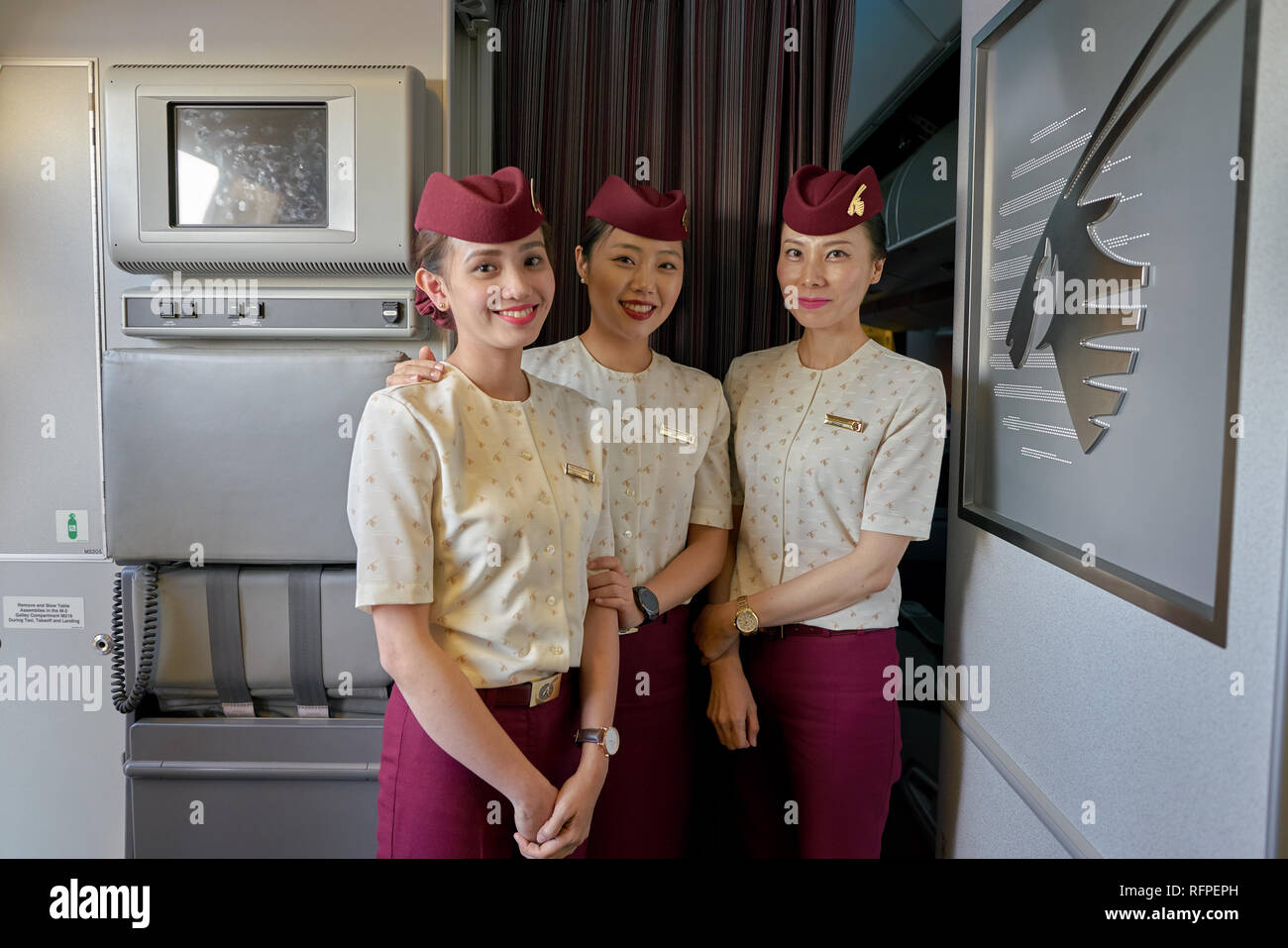 DOHA, QATAR - CIRCA JUNE, 2017: Qatar Airways crew members on board of ...