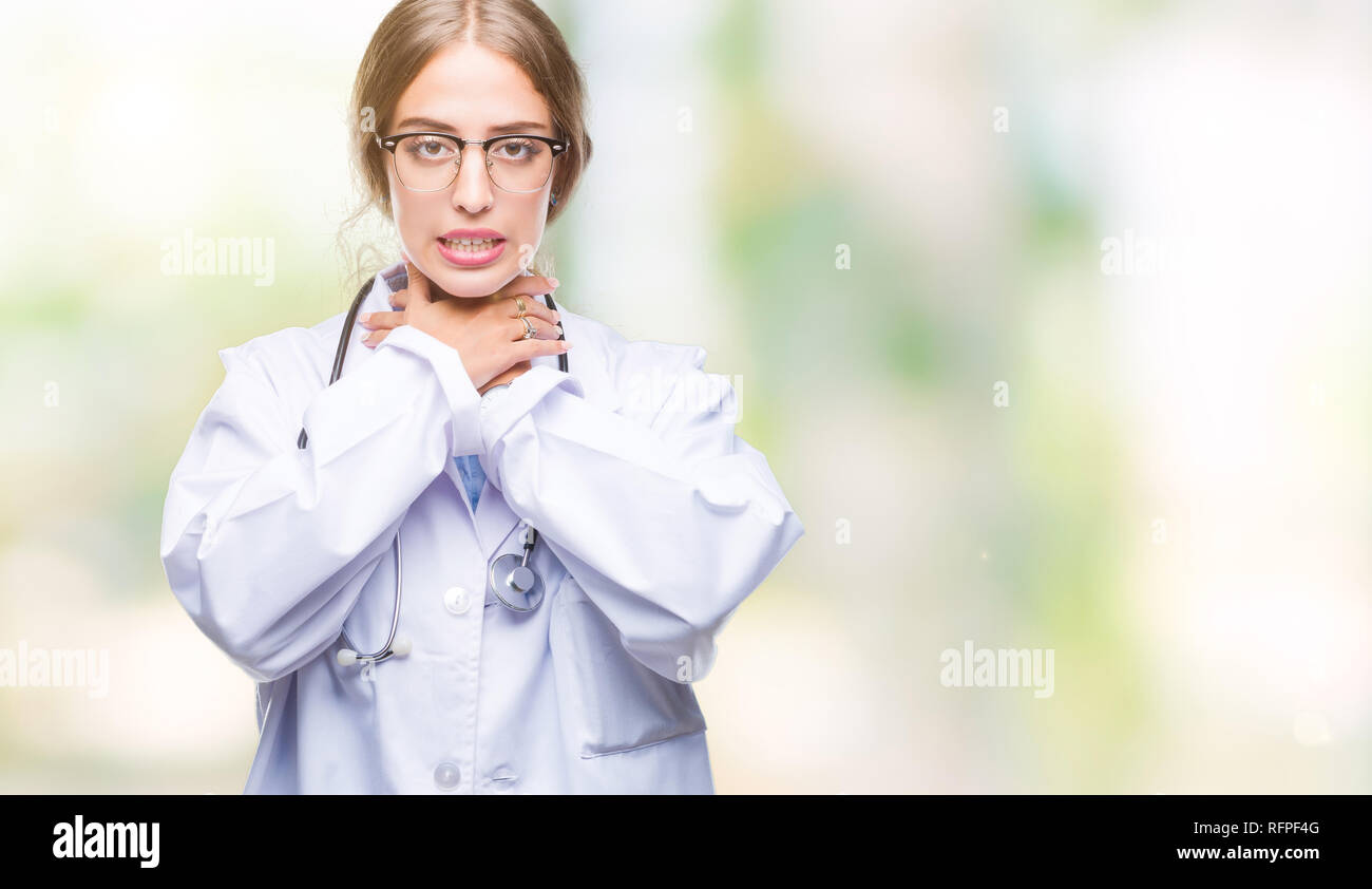 Beautiful young blonde doctor woman wearing medical uniform over ...