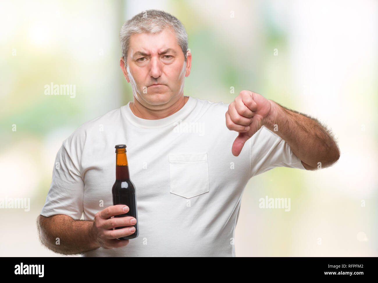 Handsome senior man drinking beer bottle over isolated background with ...