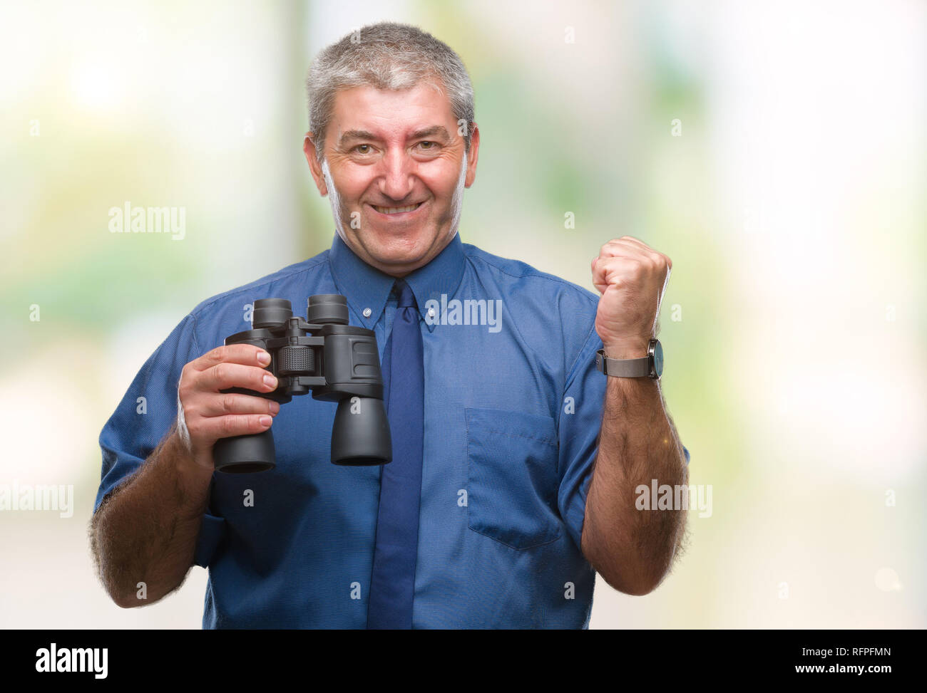Handsome senior man looking through binoculars over isolated background ...