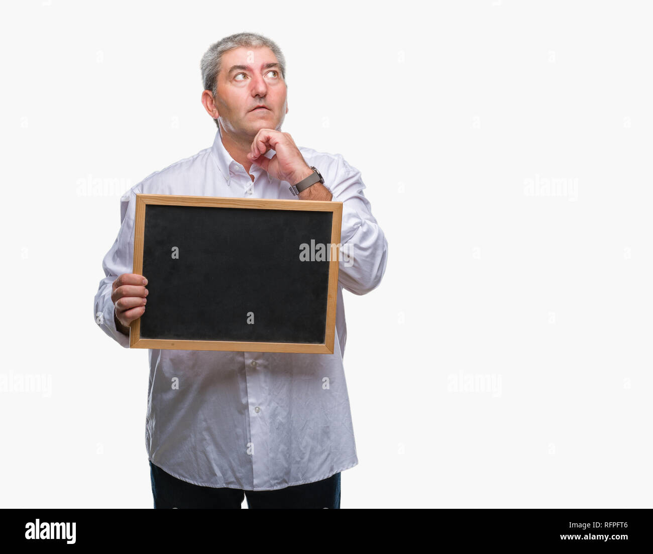 Handsome senior teacher man holding blackboard over isolated background ...