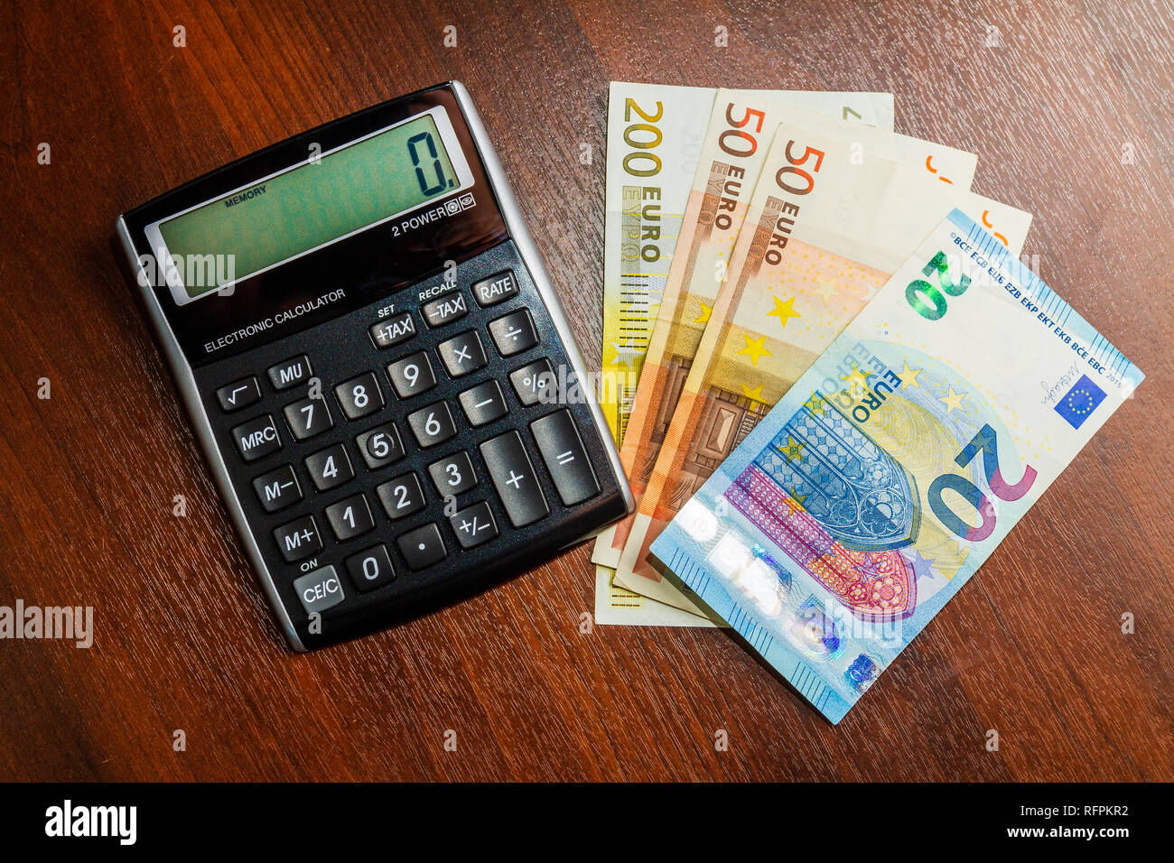 Stack of European cash money next to a electronic calculator Stock ...