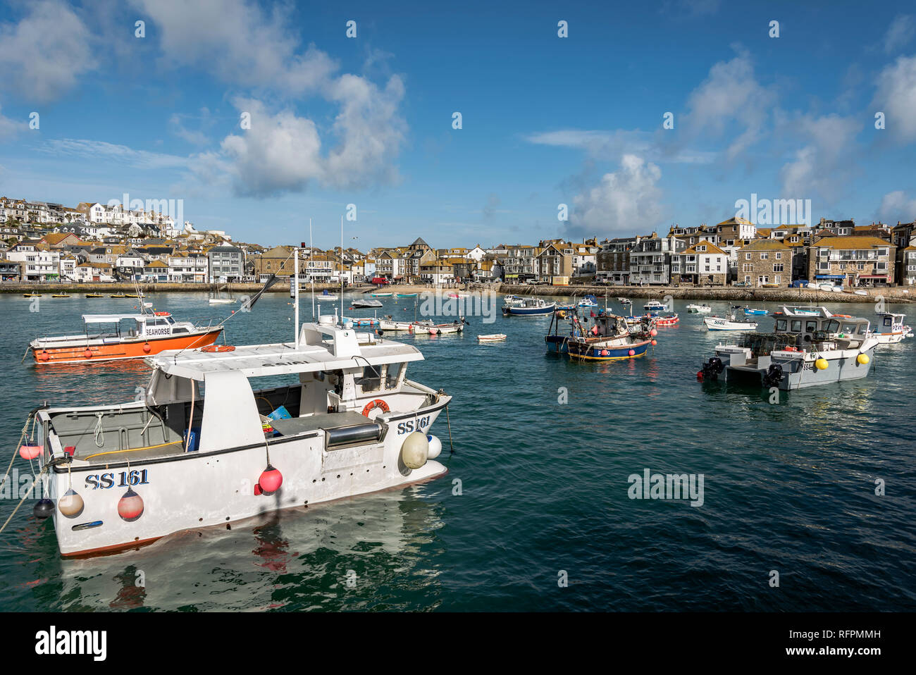 St.ives fishing fleet on moorings at high tide on a Summer evening with ...