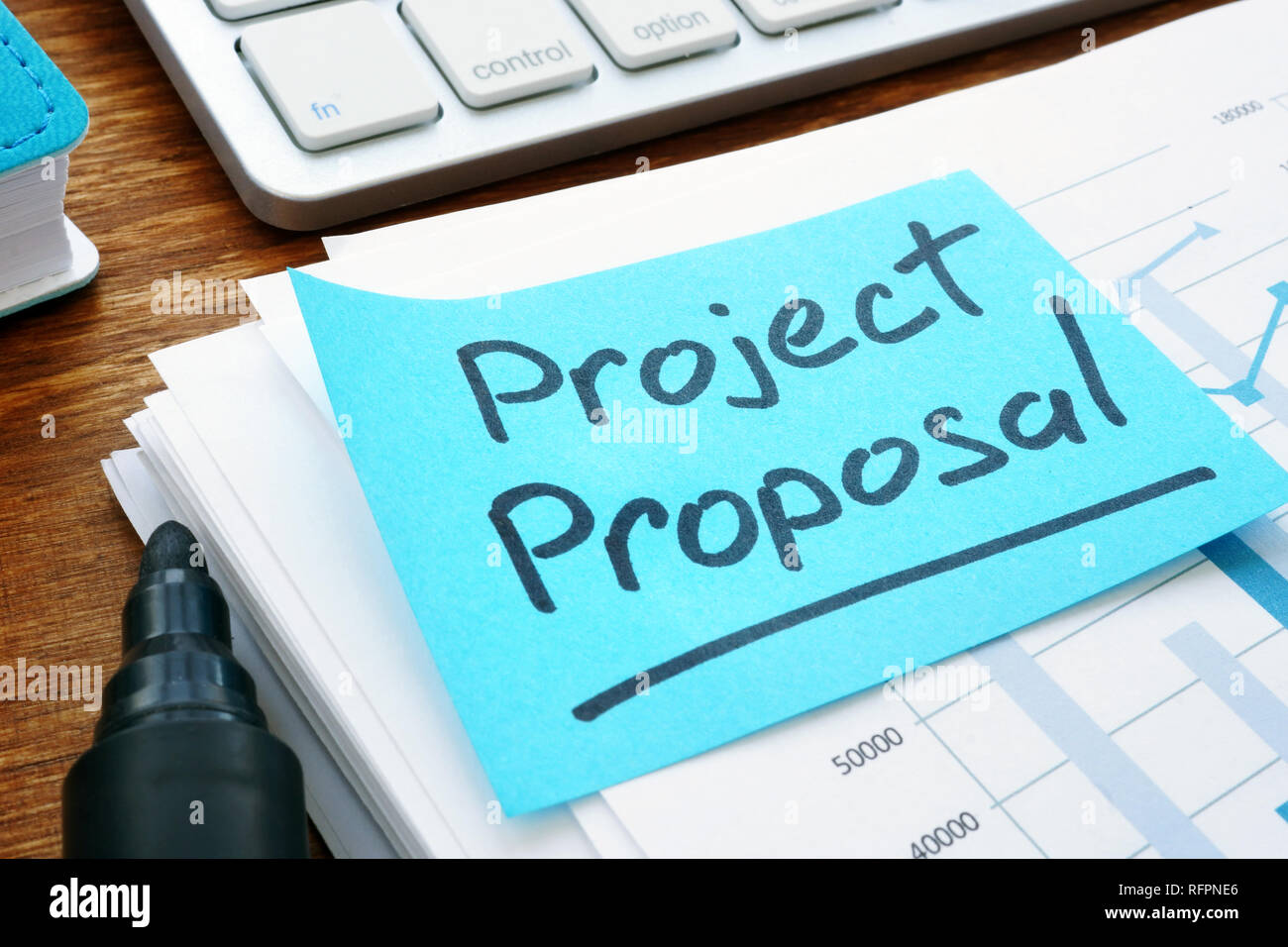 Project Proposal with stack of documents and keyboard Stock Photo - Alamy
