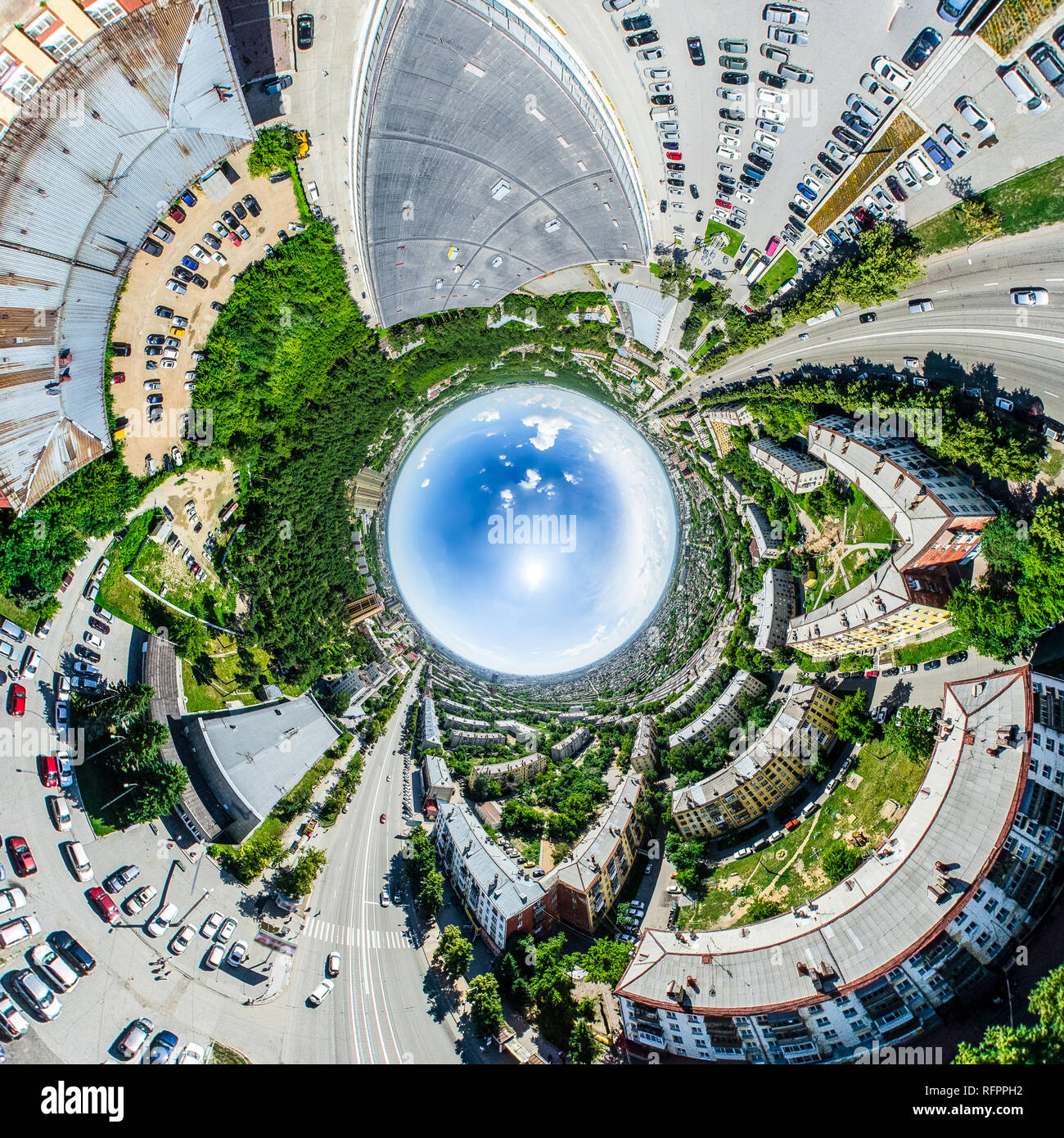 Aerial city view with crossroads and roads, houses, buildings, parks and parking lots. Sunny ...