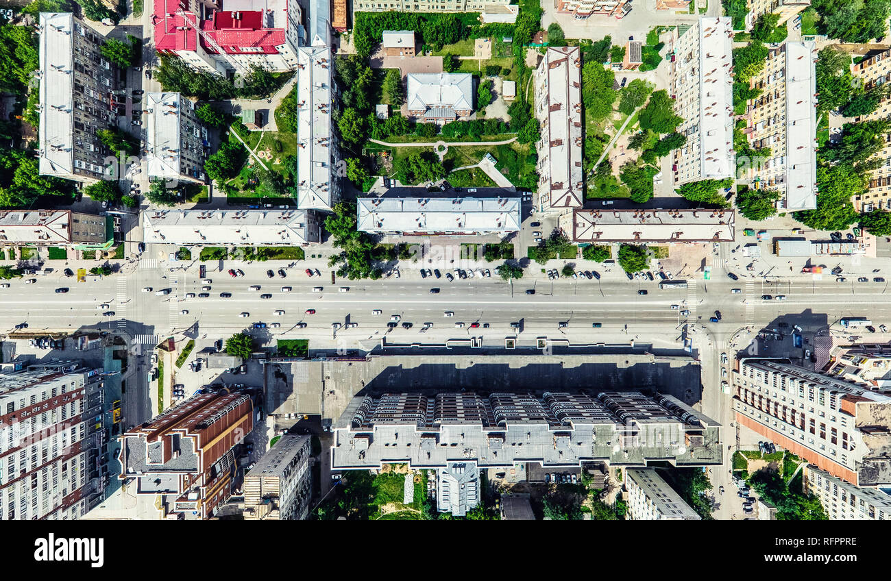 Aerial city view with crossroads and roads, houses, buildings, parks ...