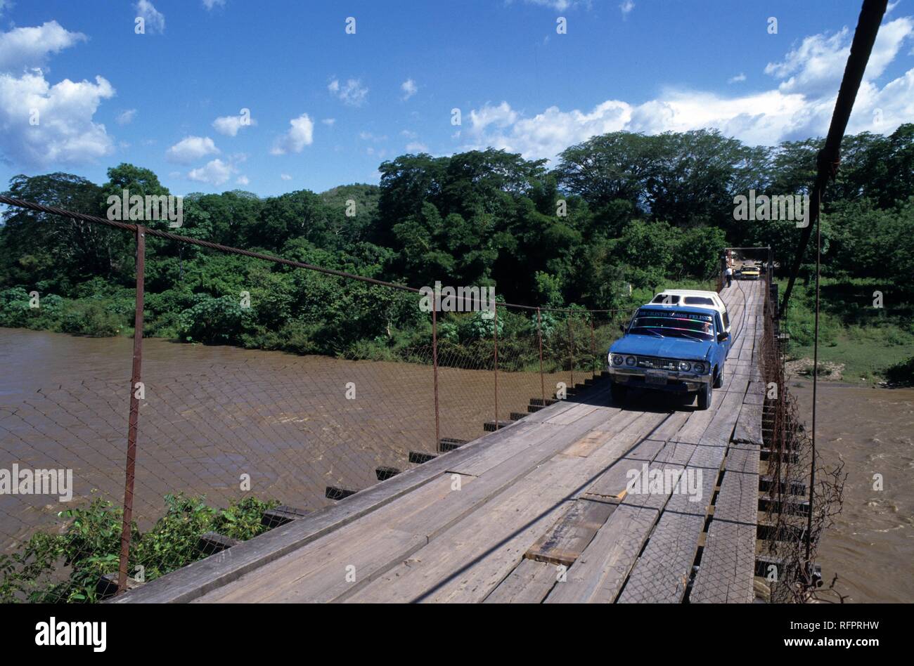 Suspension bridge above the Rio Chamelecon, Copan province, Honduras ...