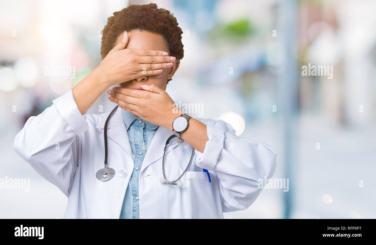 Young african american doctor woman wearing medical coat over isolated ...
