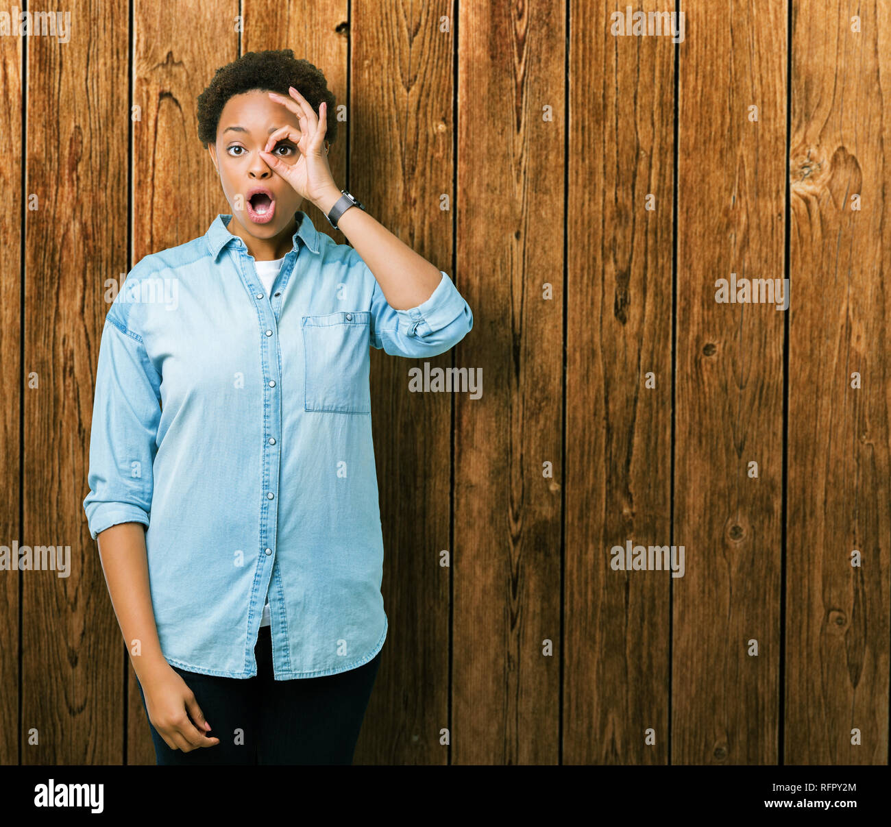 Young beautiful african american woman over isolated background doing ...