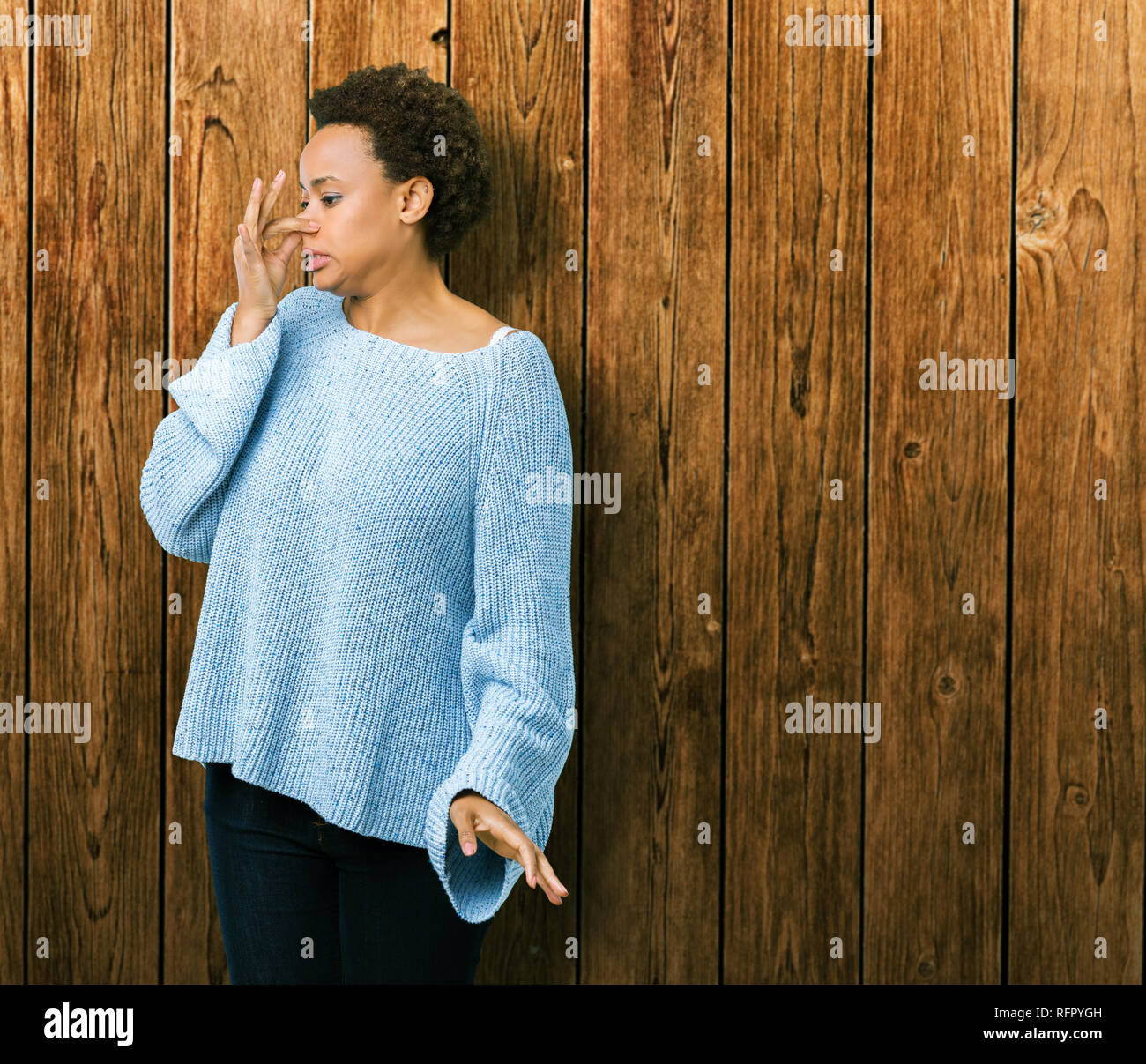 Young Beautiful African American Woman Wearing A Sweater Over Isolated