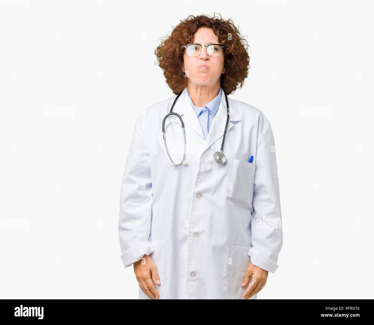 Middle ager senior doctor woman over isolated background puffing cheeks ...