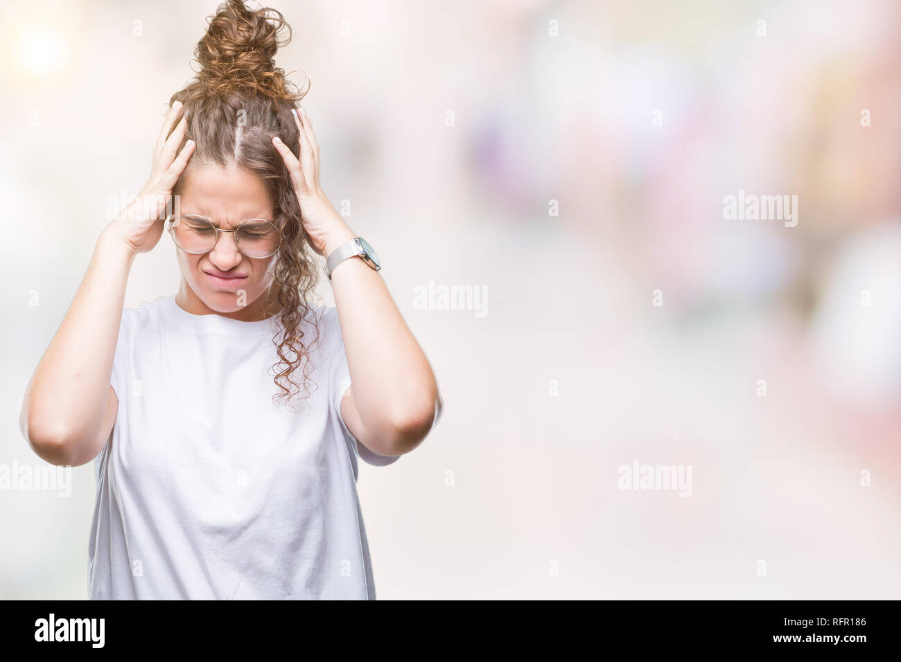 Beautiful young brunette curly hair girl wearing glasses over isolated ...