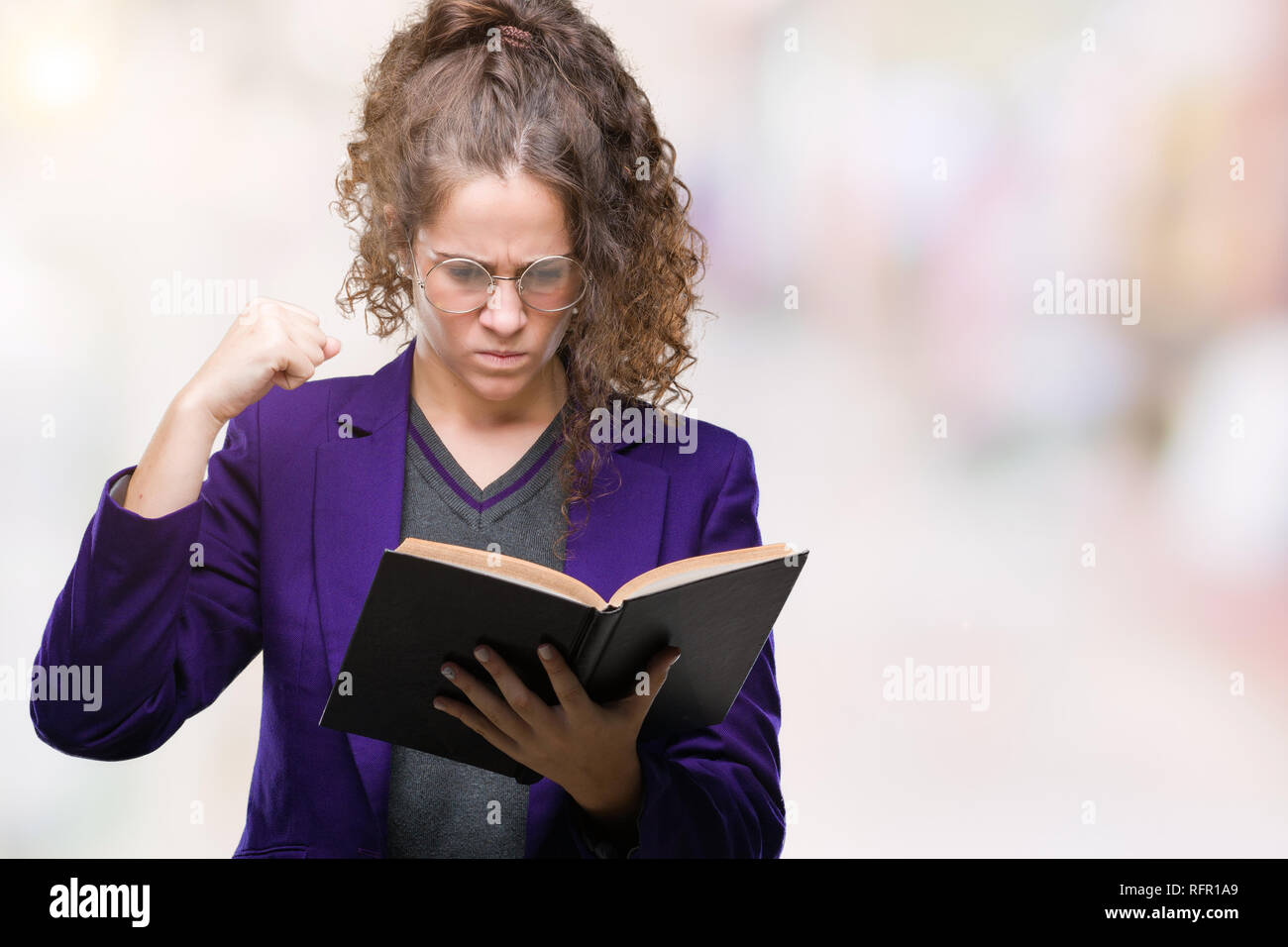 Young brunette student girl wearing school uniform reading a book over ...