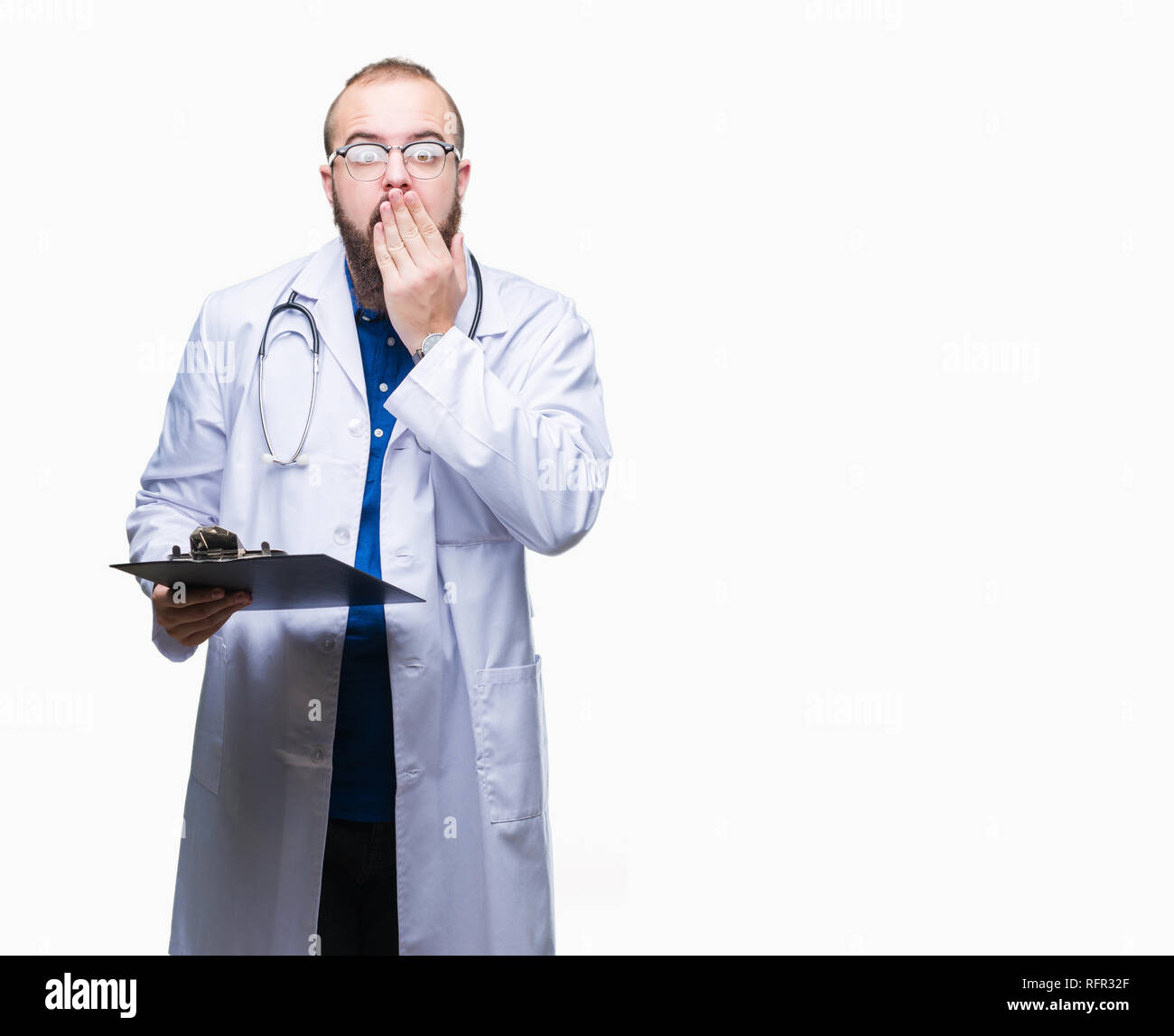 Young doctor man holding clipboard over isolated background cover mouth ...