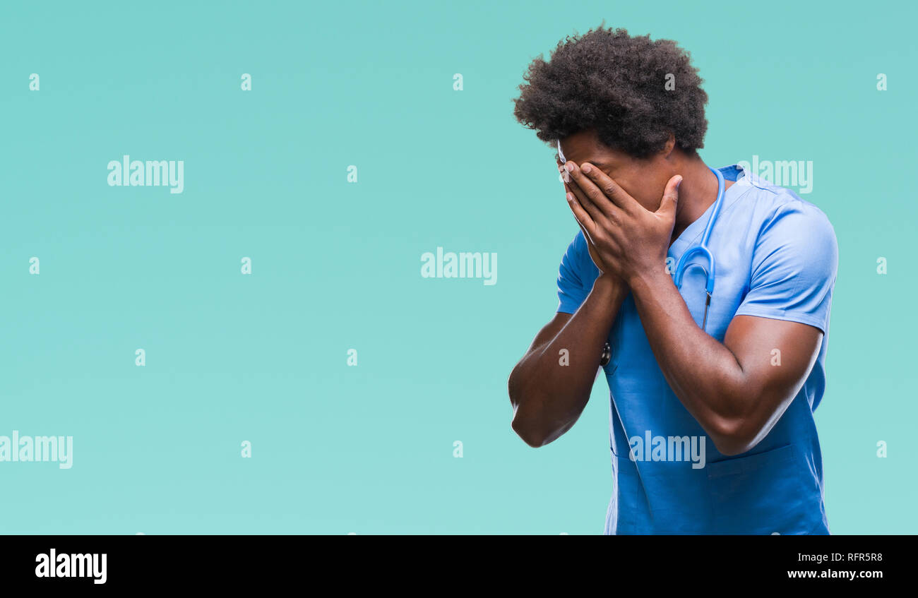 Afro american surgeon doctor man over isolated background with sad ...