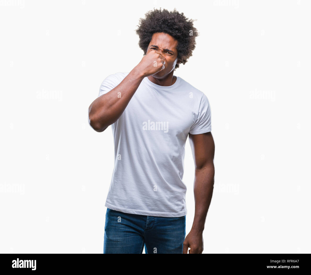 Afro american man over isolated background smelling something stinky ...