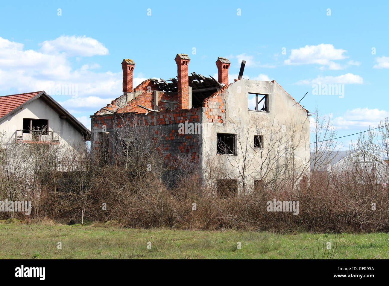 Family house bombarded during war with missing windows and completely destroyed roof with only ...