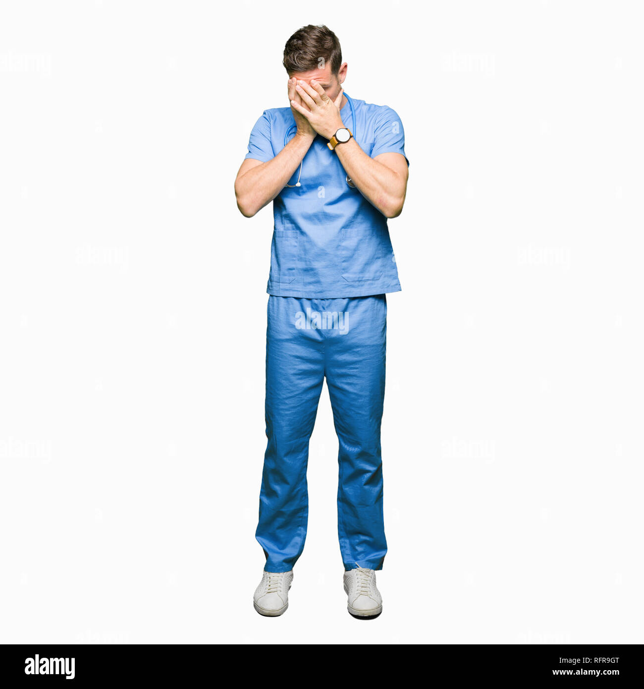 Handsome doctor man wearing medical uniform over isolated background ...