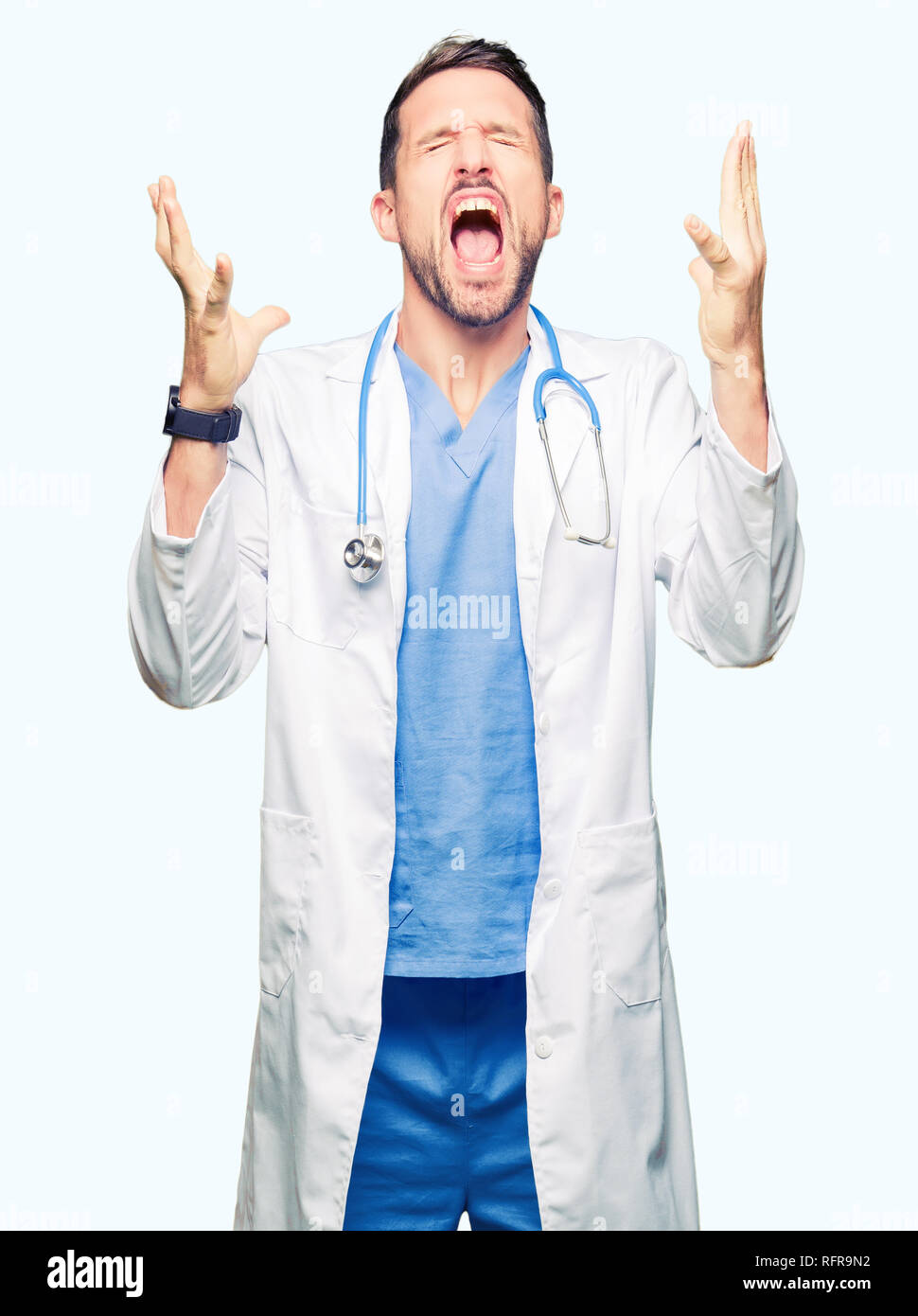 Handsome doctor man wearing medical uniform over isolated background ...