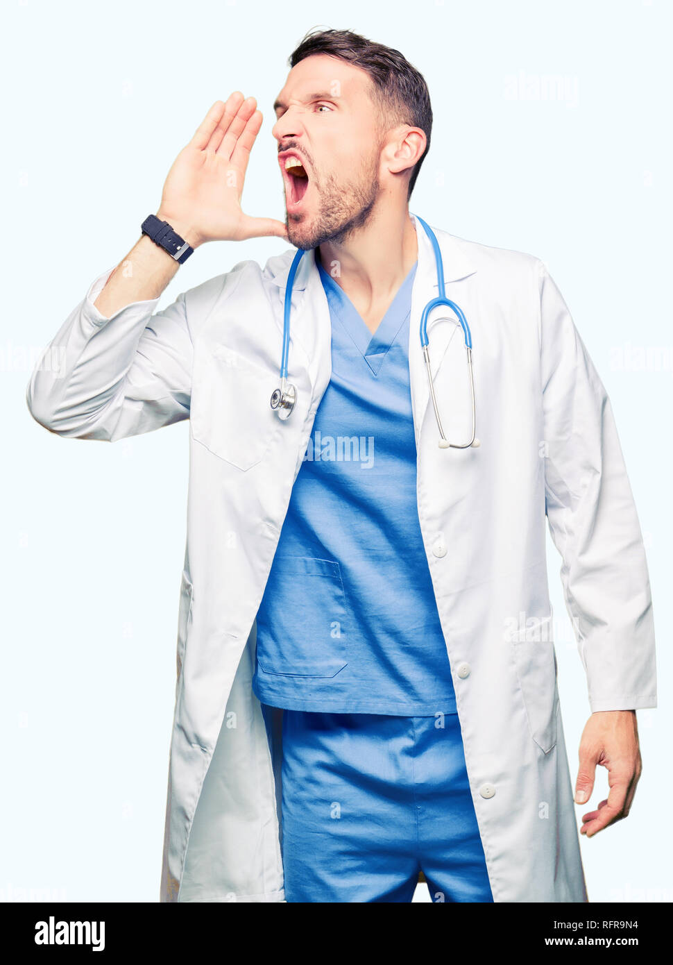 Handsome doctor man wearing medical uniform over isolated background ...