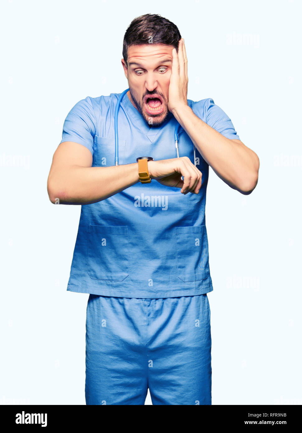 Handsome doctor man wearing medical uniform over isolated background ...