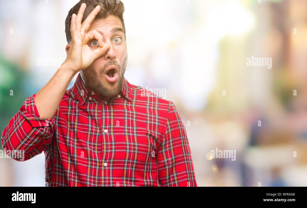 Young handsome man over isolated background doing ok gesture shocked ...