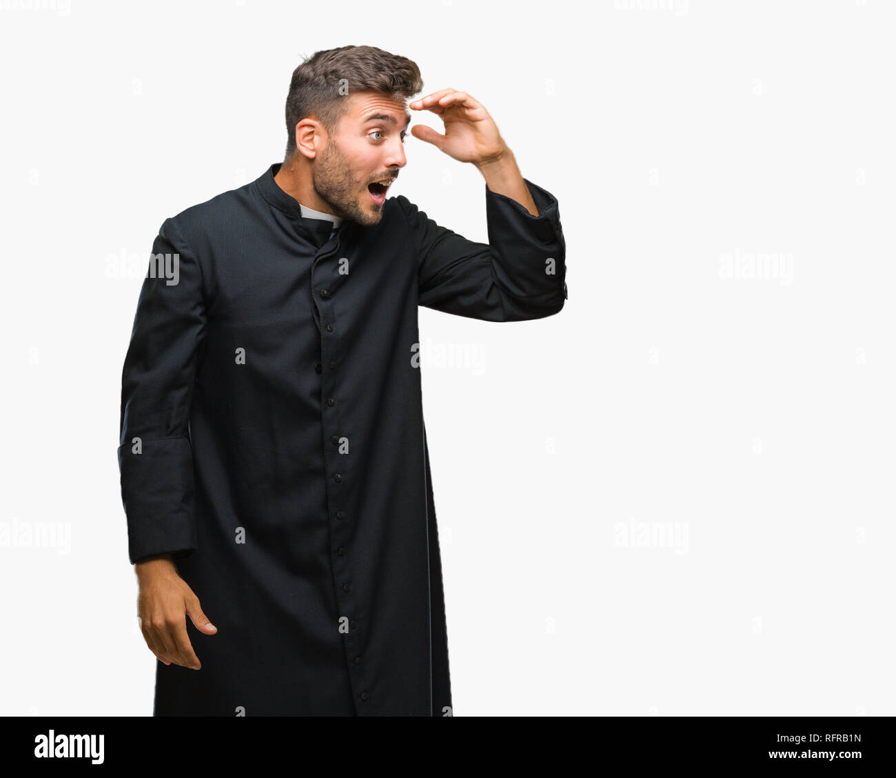 Young catholic christian priest man over isolated background very happy ...