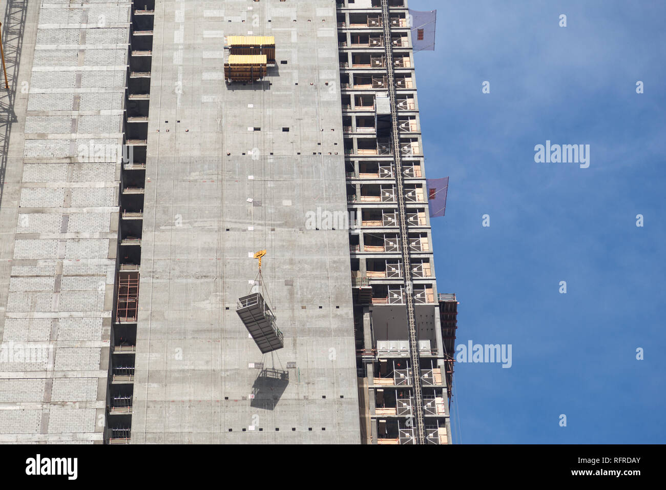 Setting up a tower crane in the construction site. The hoist winch is ...