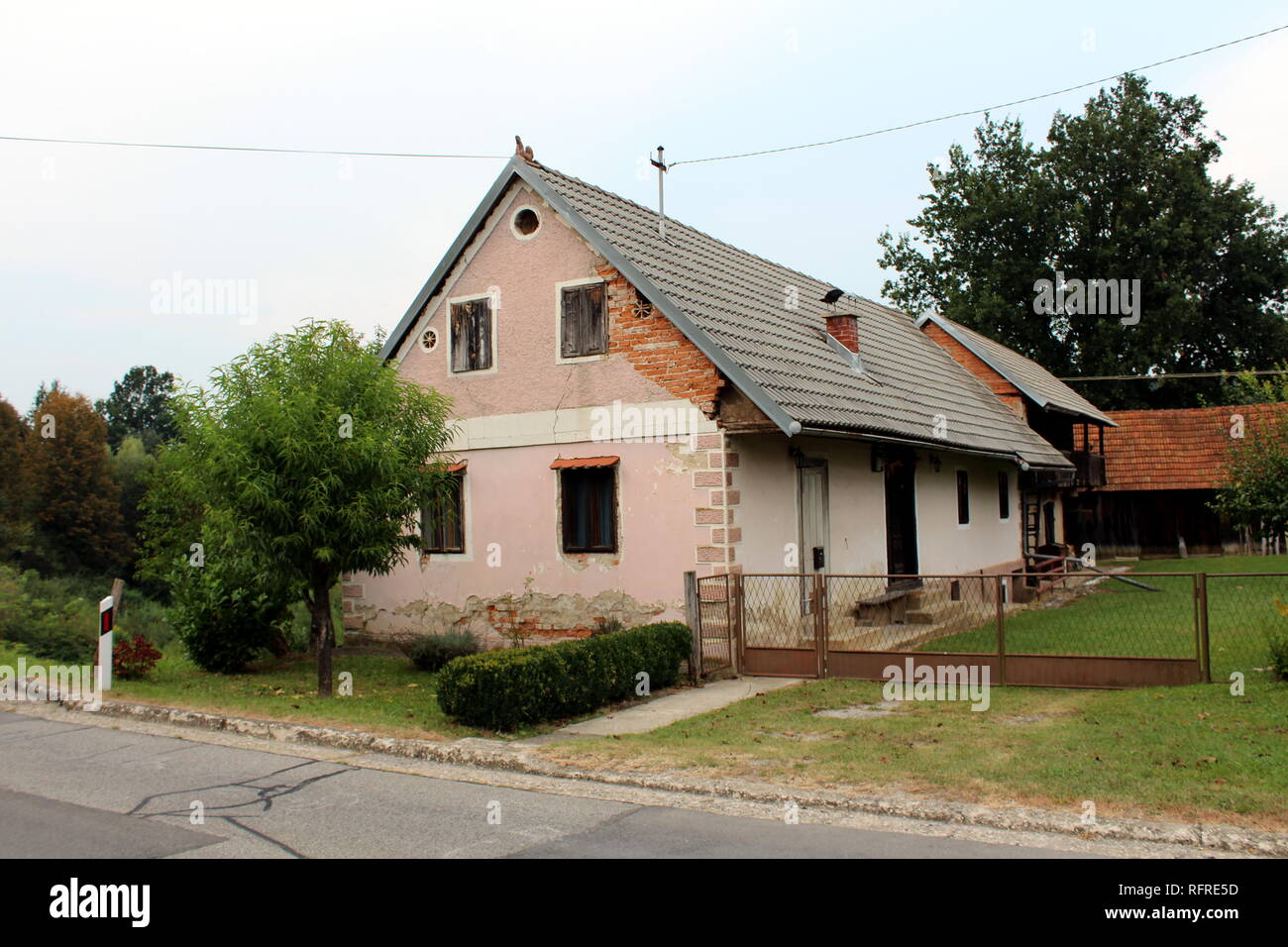 Small old suburban family house with broken facade and dilapidated ...