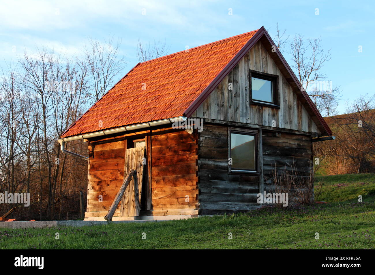 Small wooden outdoor house with new roof tiles and blocked doors ...