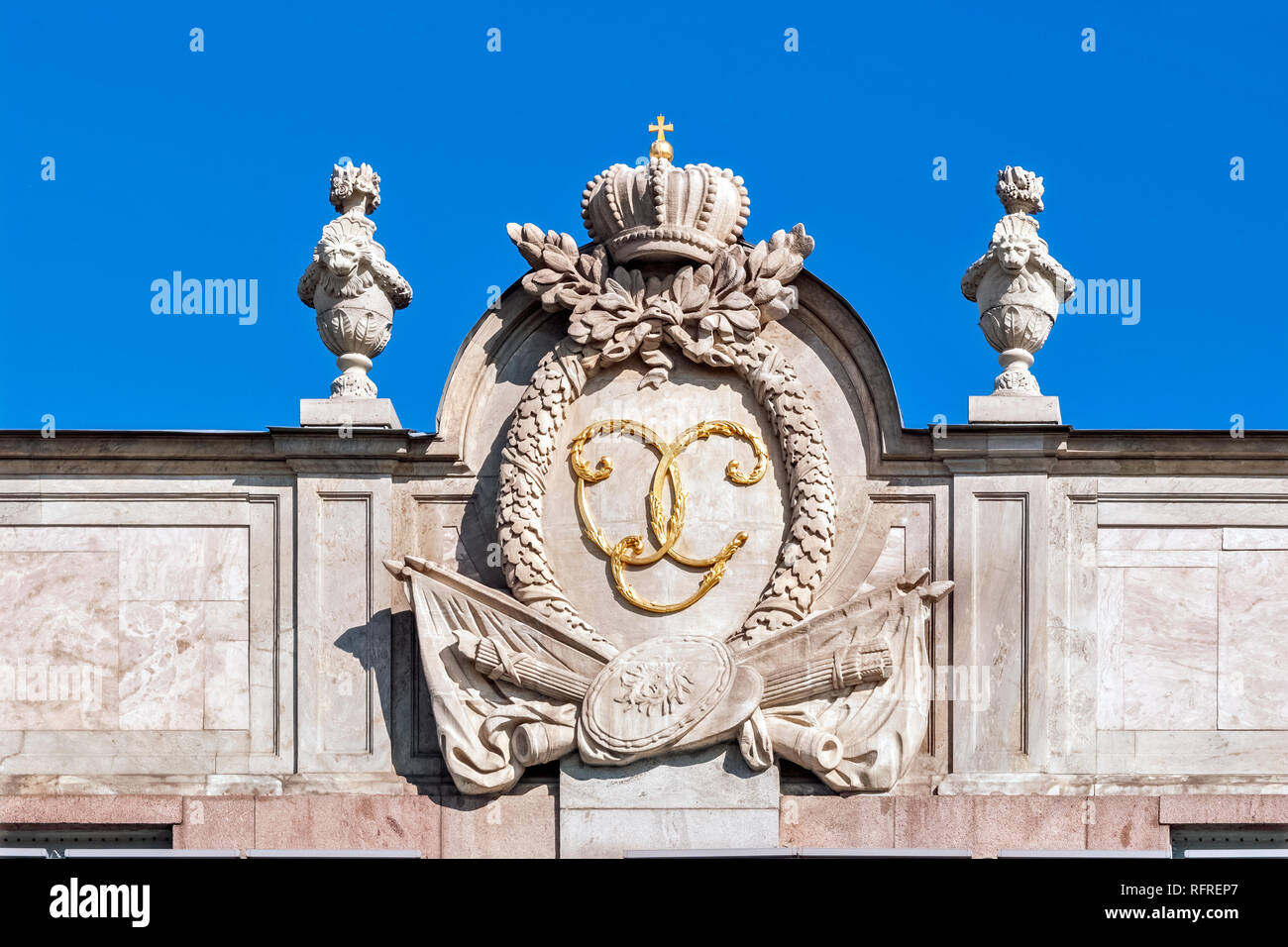 Fragment of the upper part of the building with a heraldic bas-relief ...
