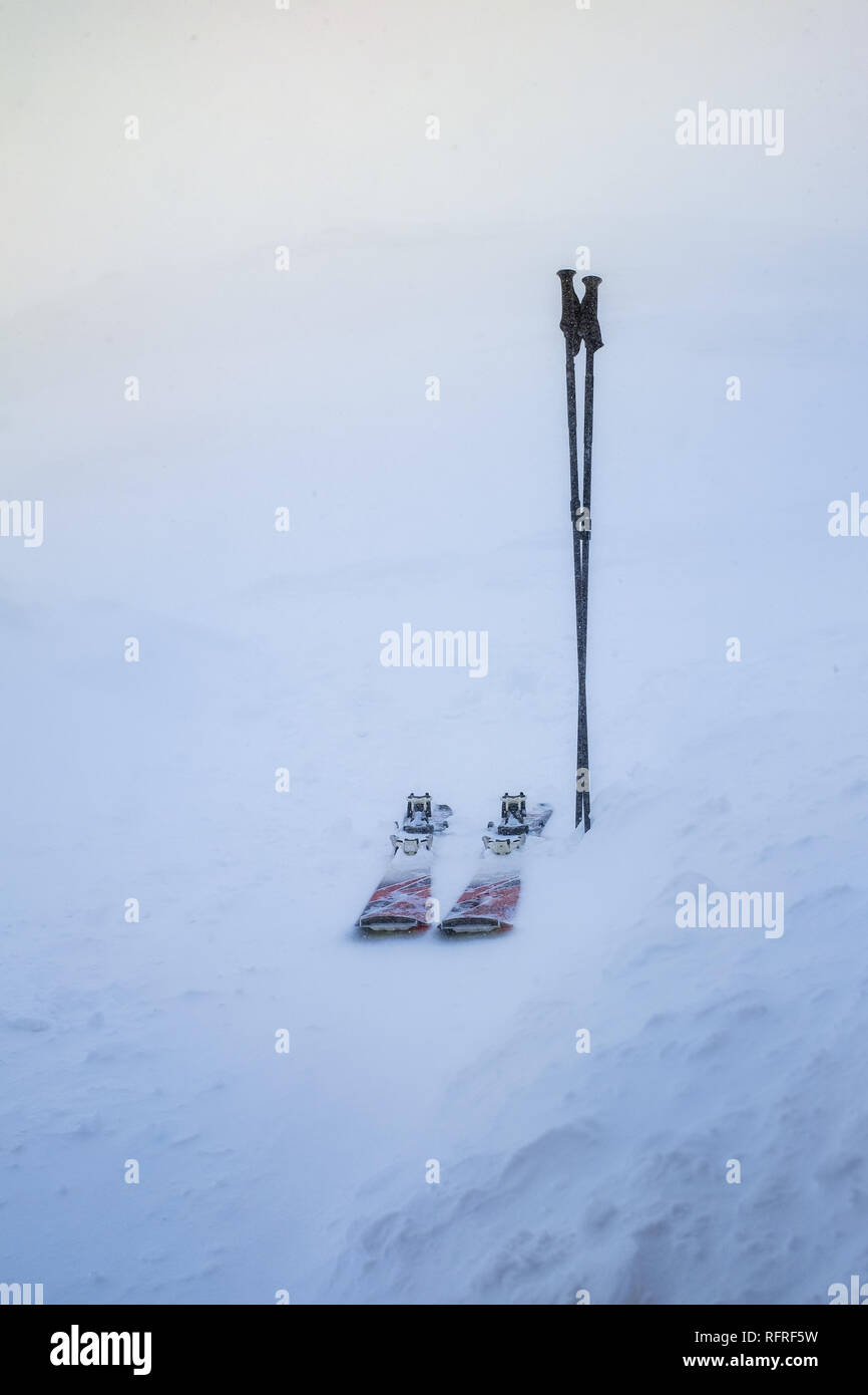 Pair of skis and sticks stuck in snow during the winter storm Stock ...