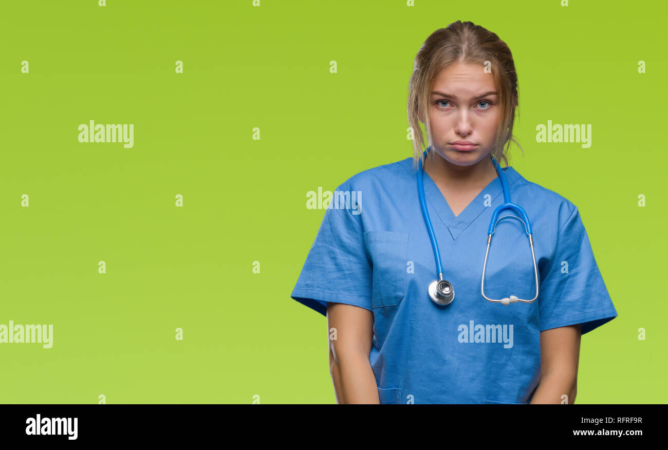 Young caucasian doctor woman wearing surgeon uniform over isolated ...
