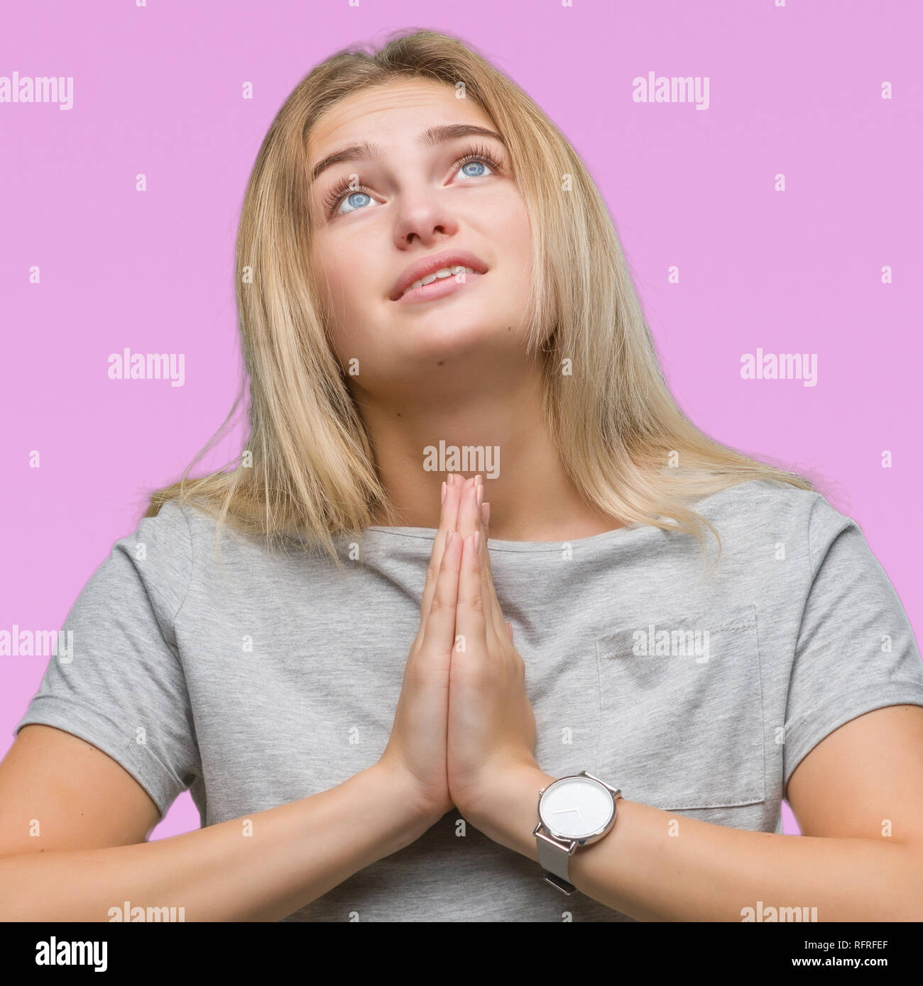 Young caucasian woman over isolated background begging and praying with ...