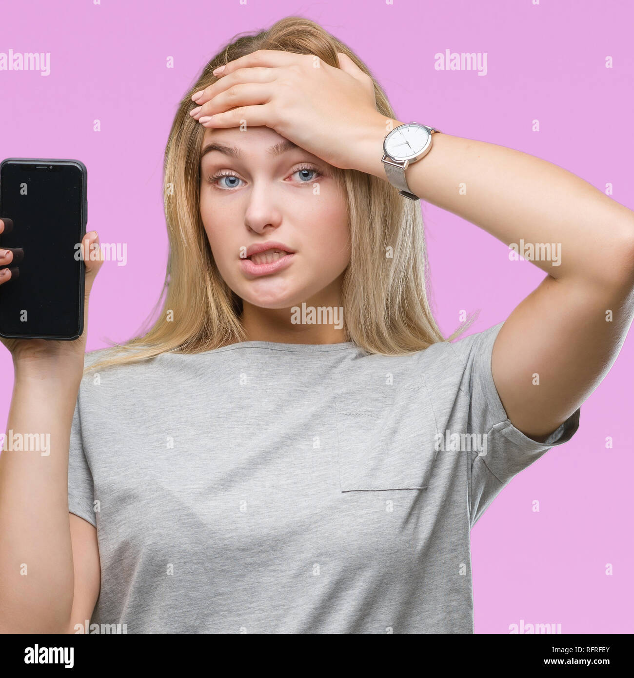 Young caucasian woman showing screen of smartphone over isolated ...