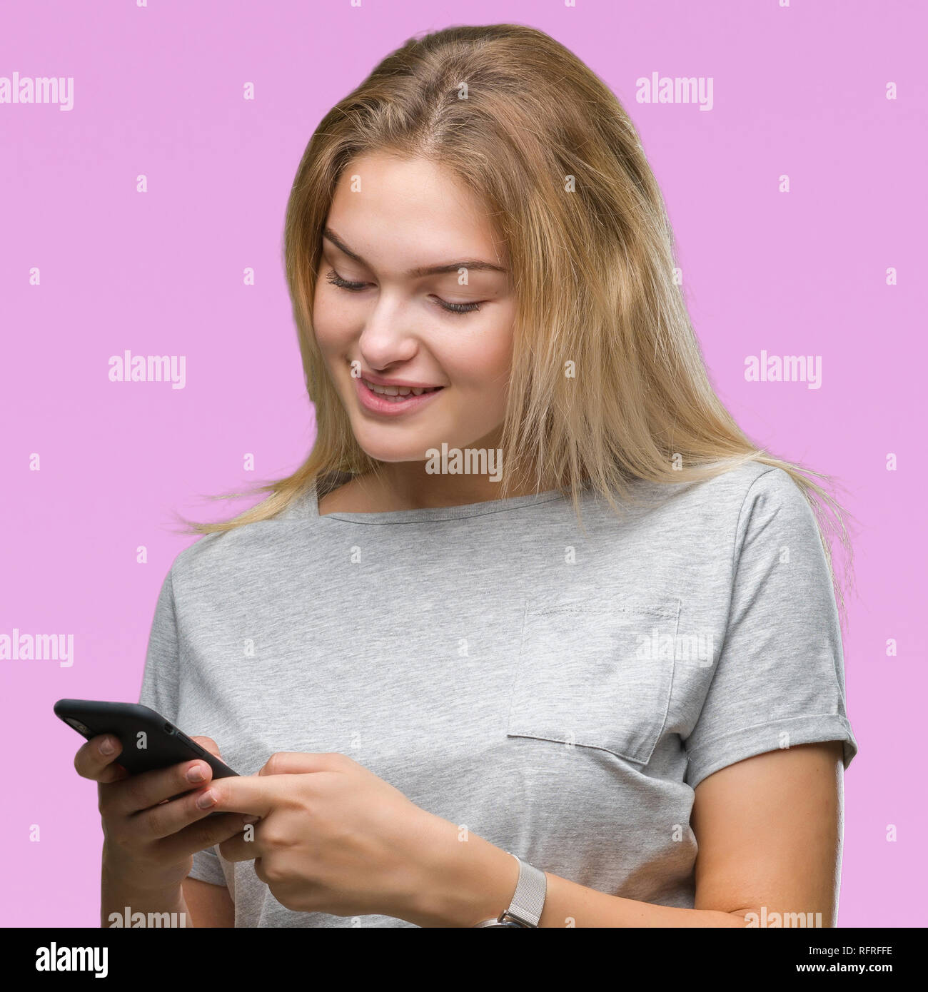 Young caucasian woman sending message using smartphone over isolated ...
