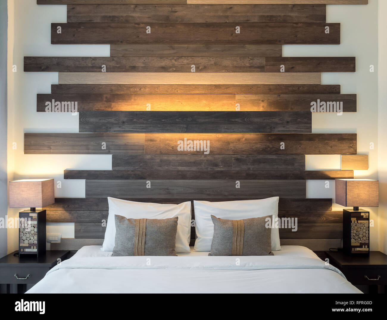 Empty double bed and lamp on wooden table on side of bed in luxury and ...