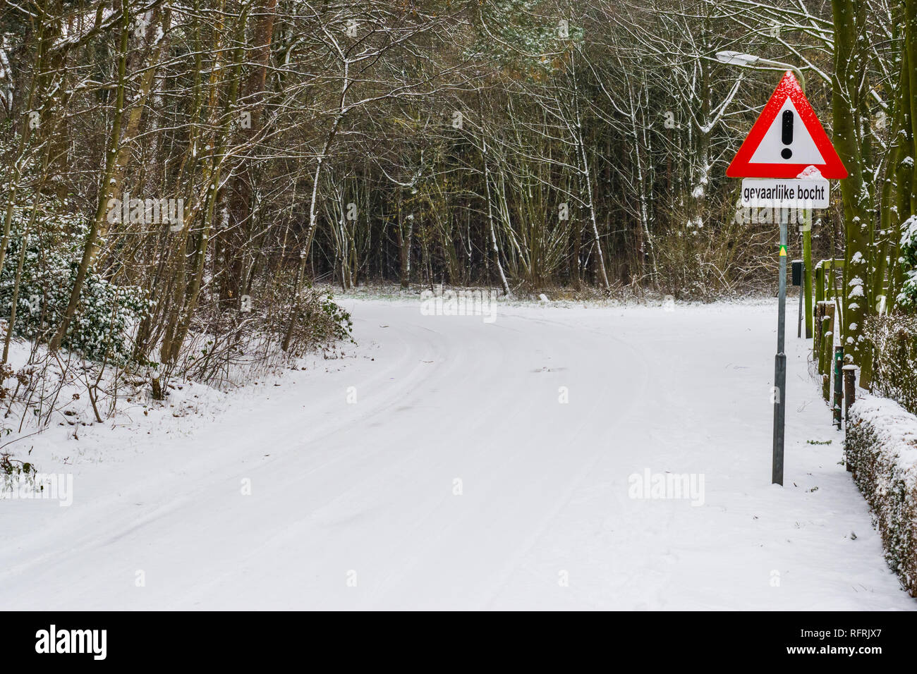 Dutch warning traffic sign, dangerous turn in bad weather condition ...