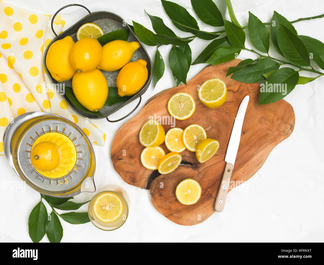 beautiful still life with lemons on white paper background and wooden ...