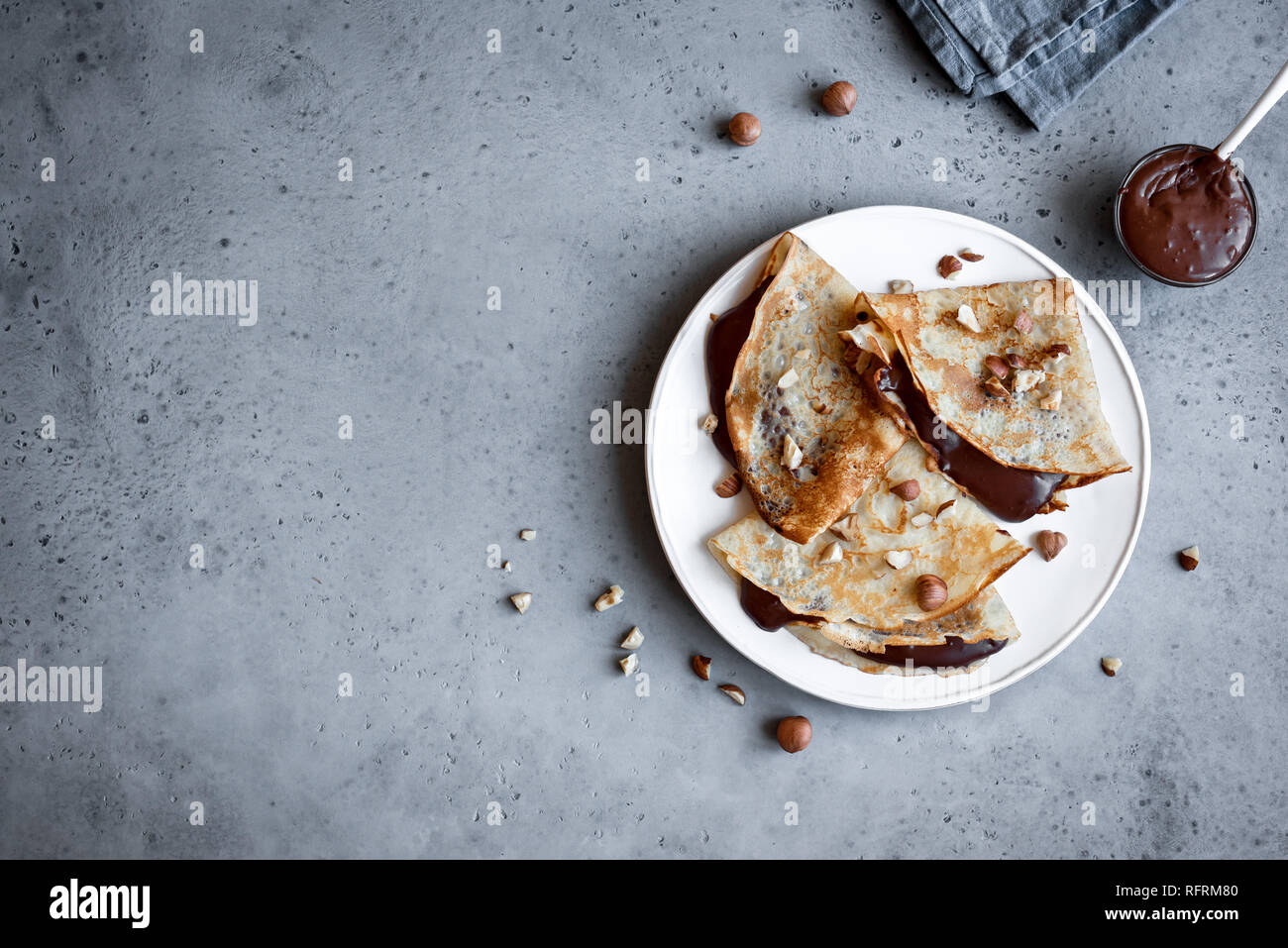 Crepes with chocolate spread and hazelnuts. Homemade thin crepes for ...