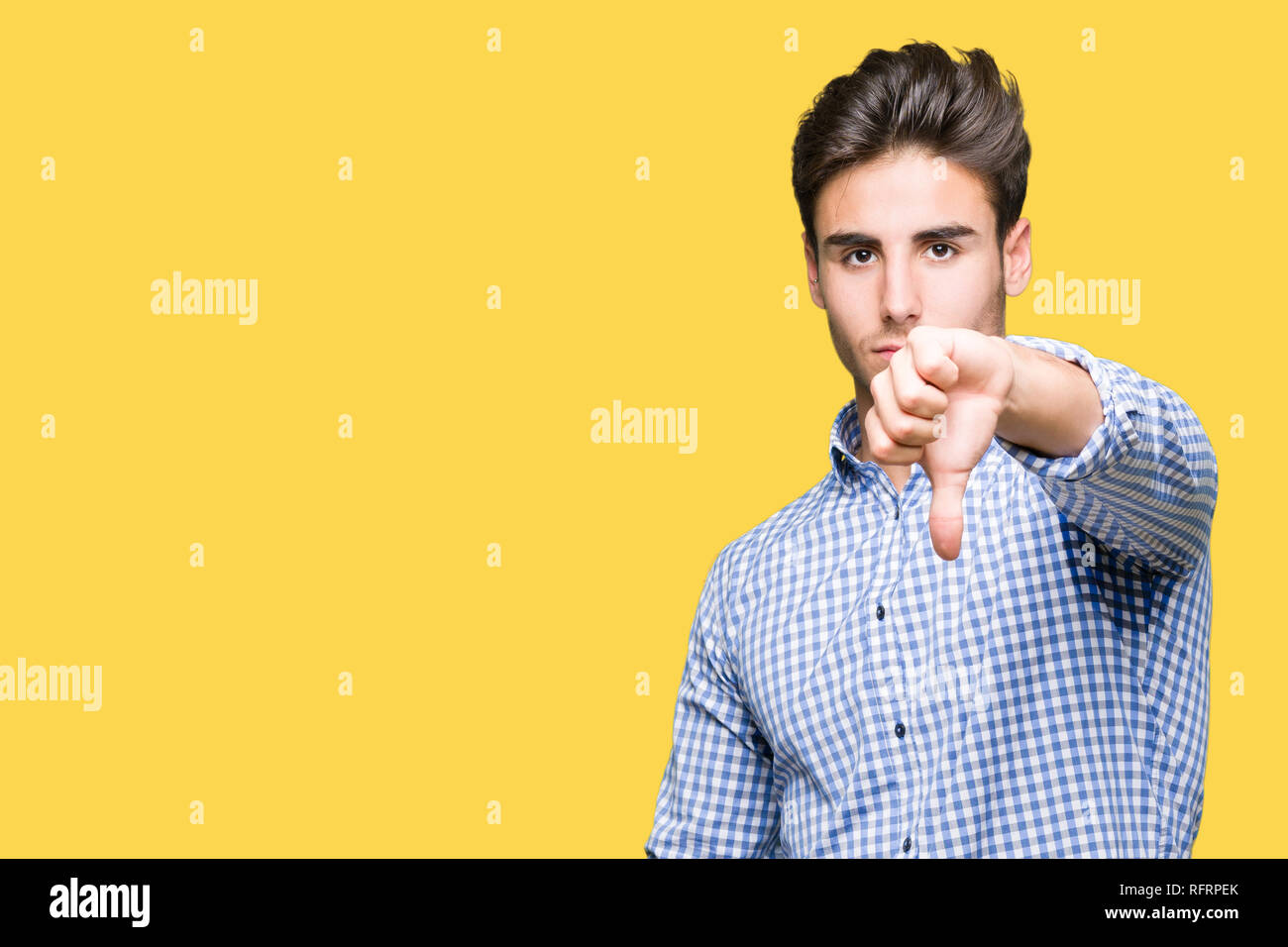 Young handsome business man over isolated background looking unhappy ...