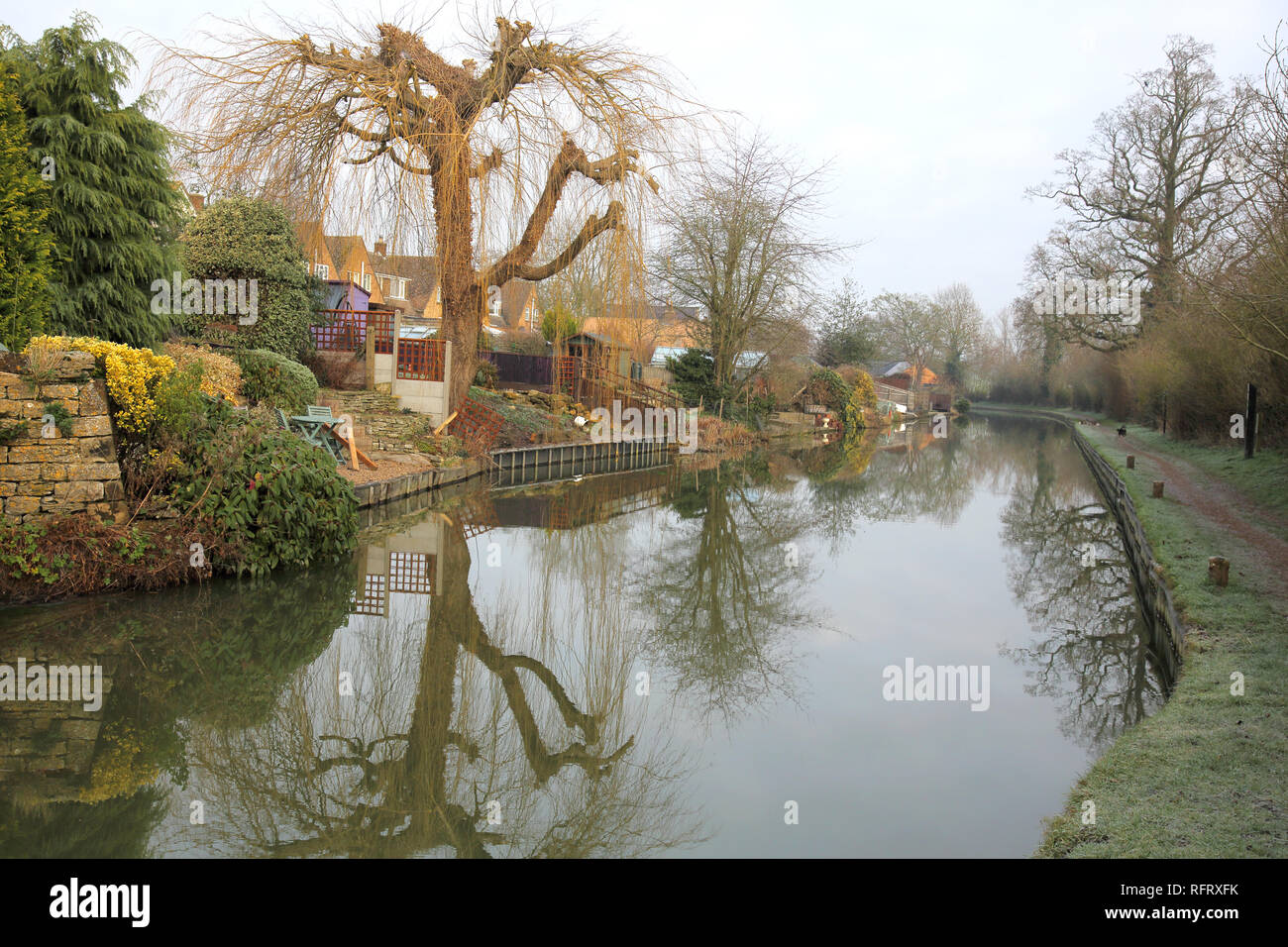winter tree reflections on the oxford canal at cropredy in oxfordshire ...