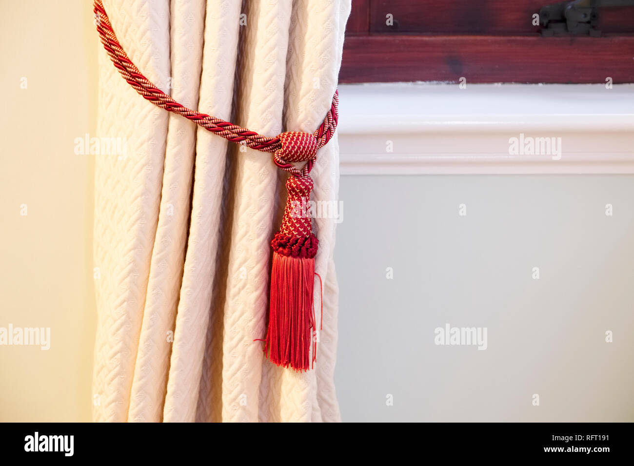 Curtain tie back fastener red detail Stock Photo - Alamy