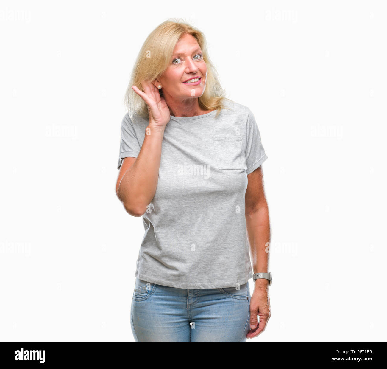 Middle age blonde woman over isolated background smiling with hand over ...