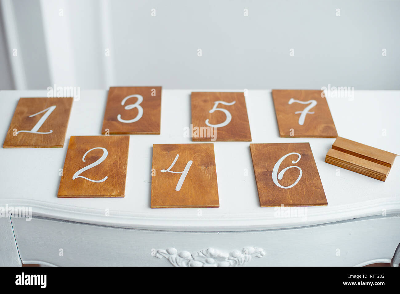 Vintage rectangular shaped wooden number buttons on a white wooden ...