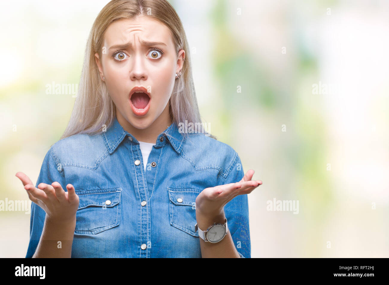 Young blonde woman over isolated background afraid and shocked with ...