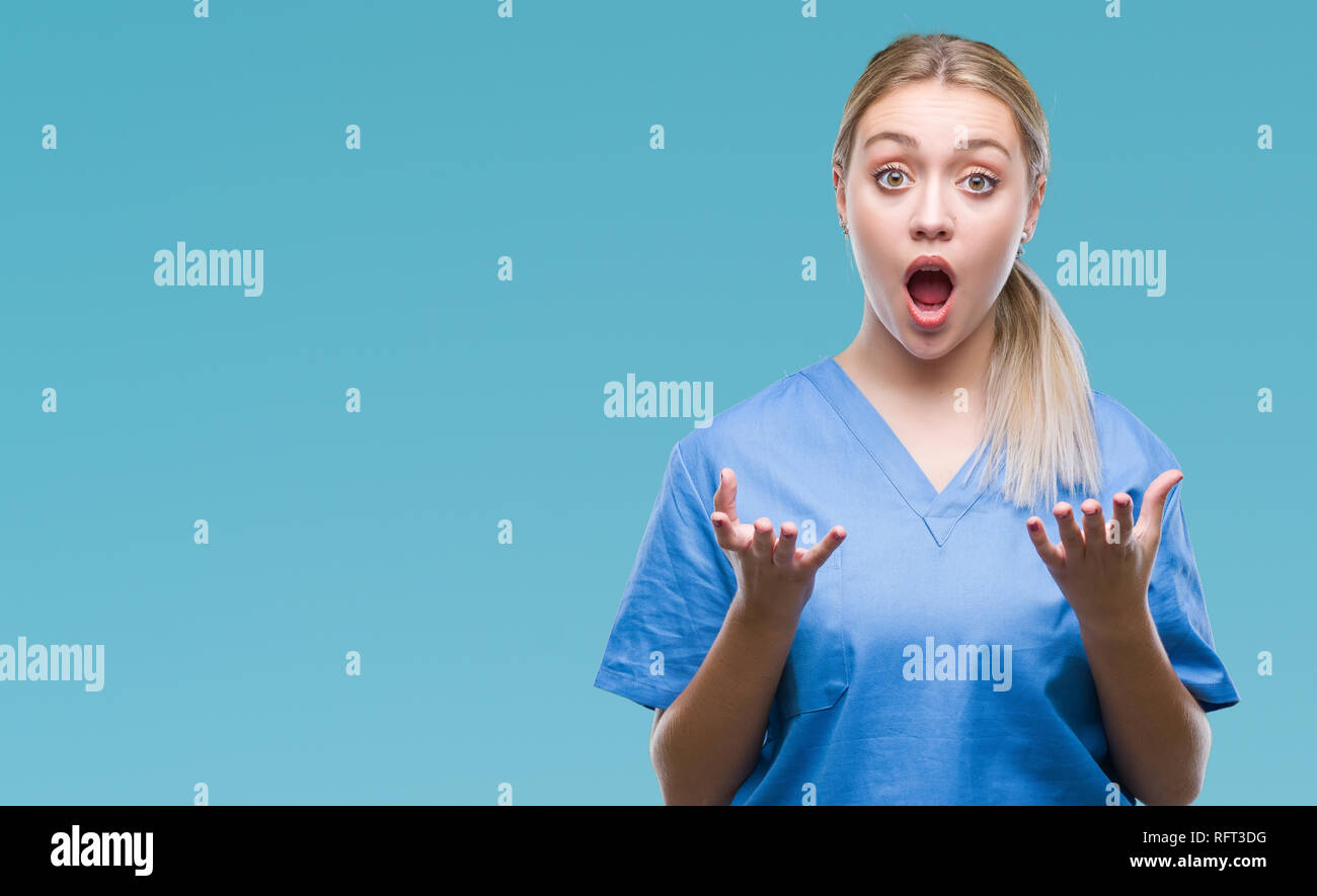 Young blonde surgeon doctor woman wearing medical uniform over isolated ...