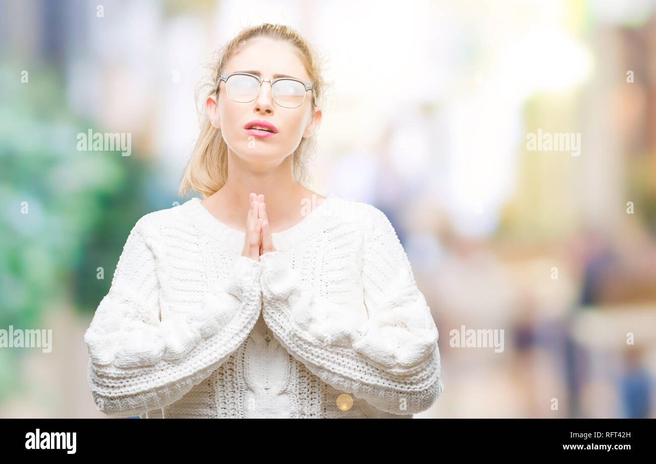 Young beautiful blonde woman wearing glasses over isolated background ...