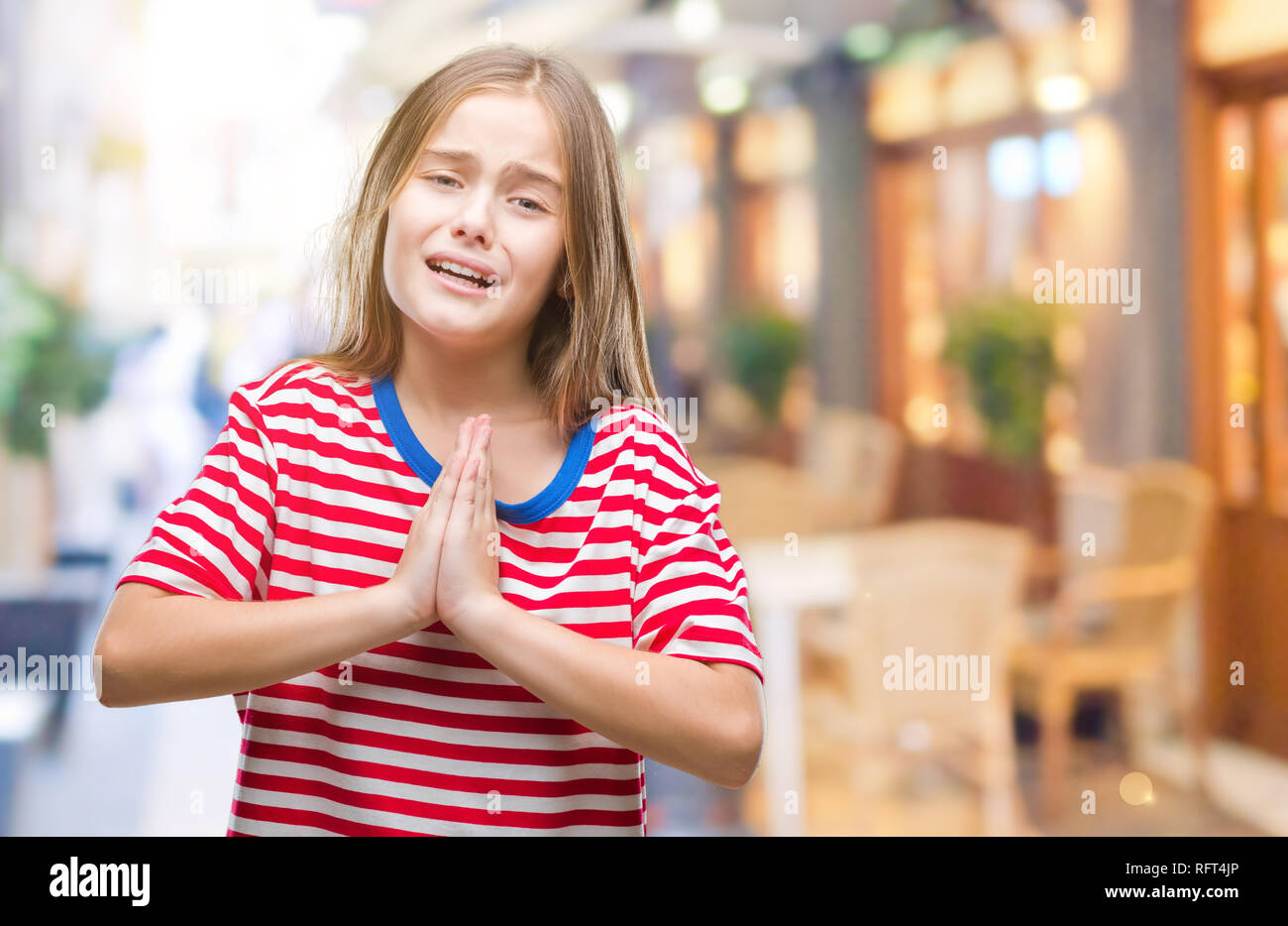 Young beautiful girl over isolated background begging and praying with ...